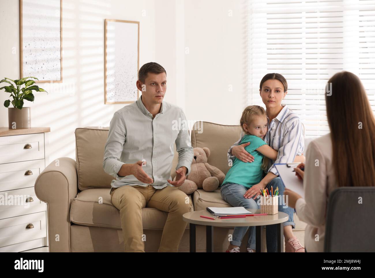 Family on appointment with child psychotherapist indoors Stock Photo ...
