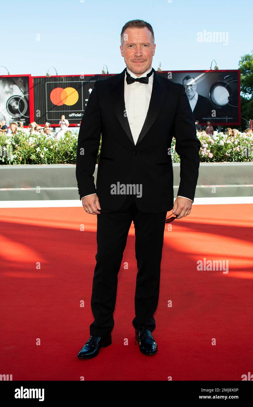 Actor Aleksei Kravchenko poses for photographers upon arrival at the ...