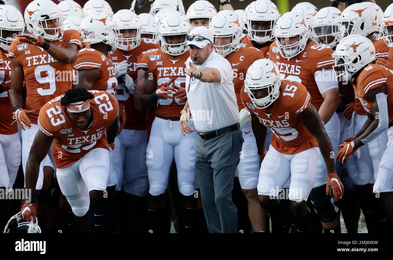 Texas head coach Tom Herman, center, works with his team before an NCAA ...