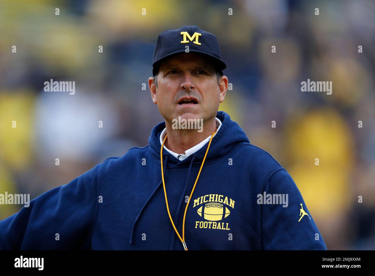 Michigan head coach Jim Harbaugh watches during warmups before an NCAA ...