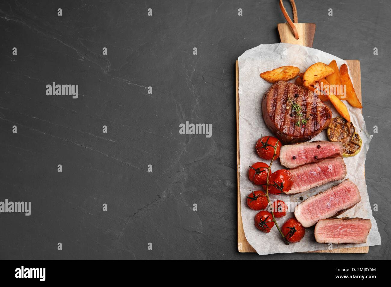 Delicious beef served on black table, top view. Space for text Stock ...