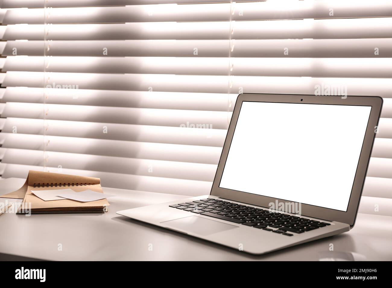 Laptop on desk near window in office. Comfortable workplace Stock Photo ...