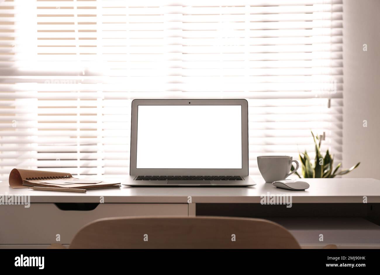 Laptop on desk near window in office. Comfortable workplace Stock Photo ...