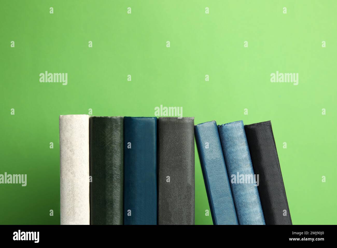 Collection of old books on green background Stock Photo - Alamy