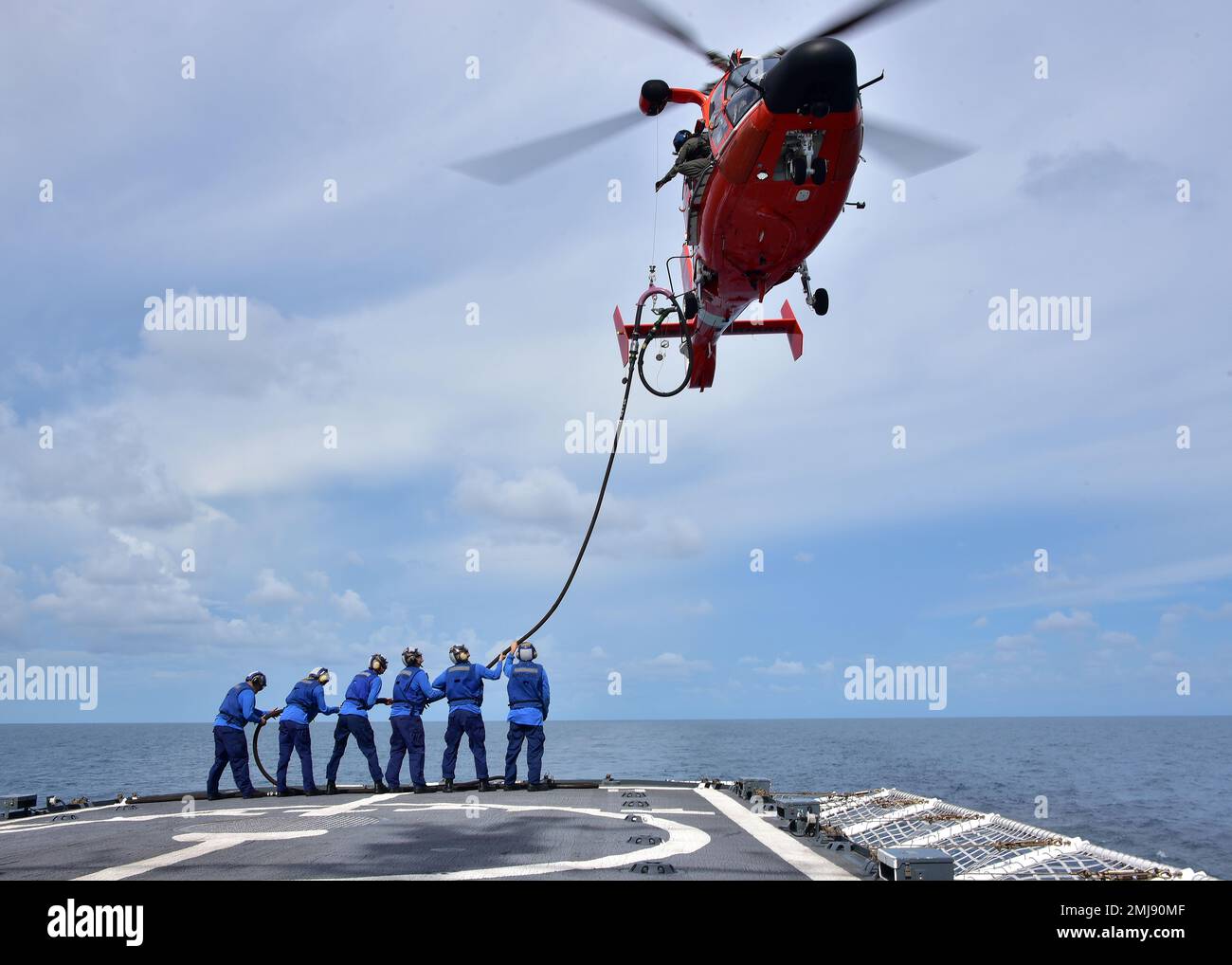 Coast Guard Cutter Resolute crewmen conduct in-flight refueling during ...