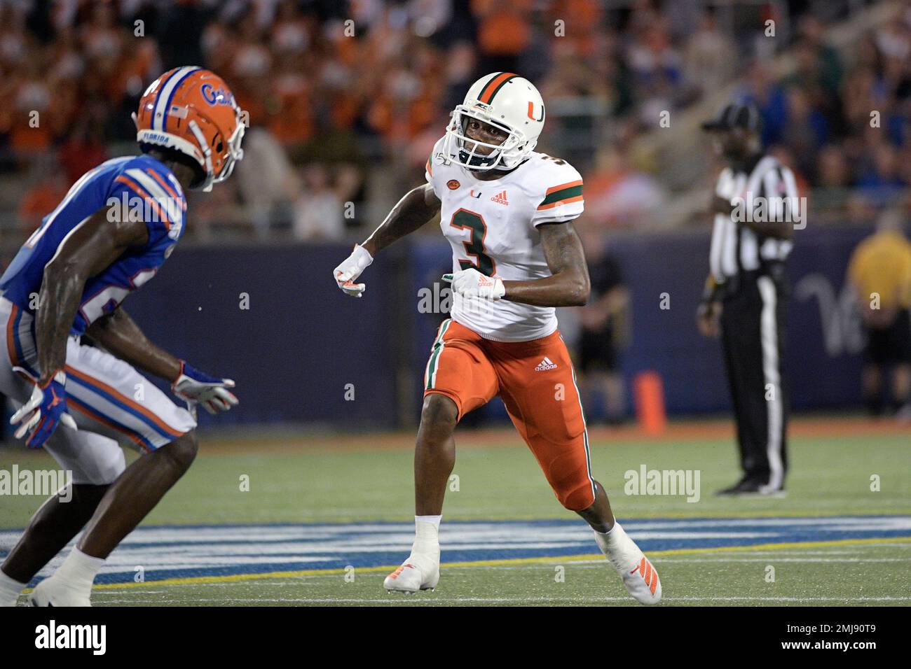 Miami wide receiver Mike Harley (3) runs a route in front of Florida ...