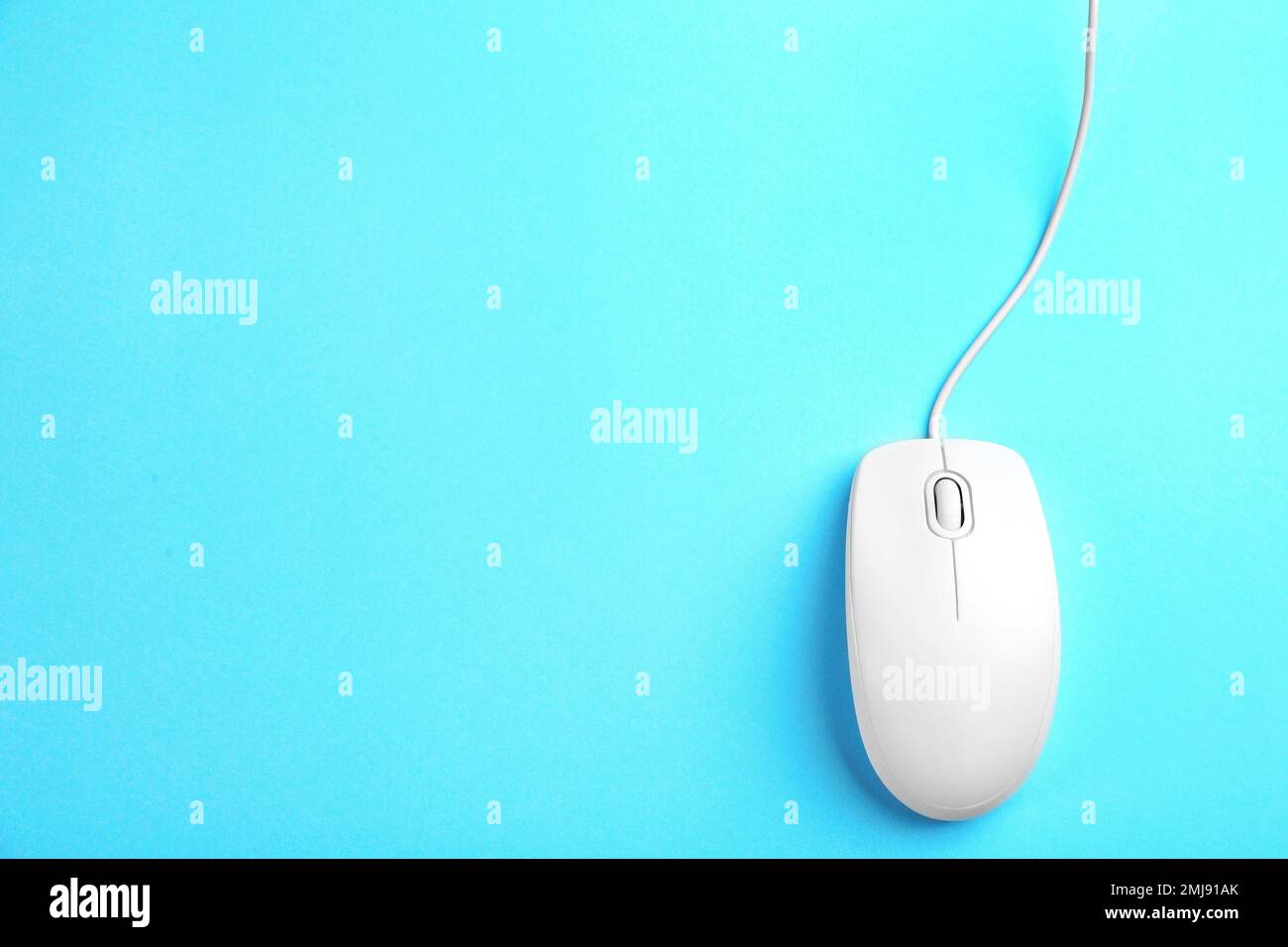 Modern wired mouse on light blue background, top view. Space for text Stock Photo - Alamy
