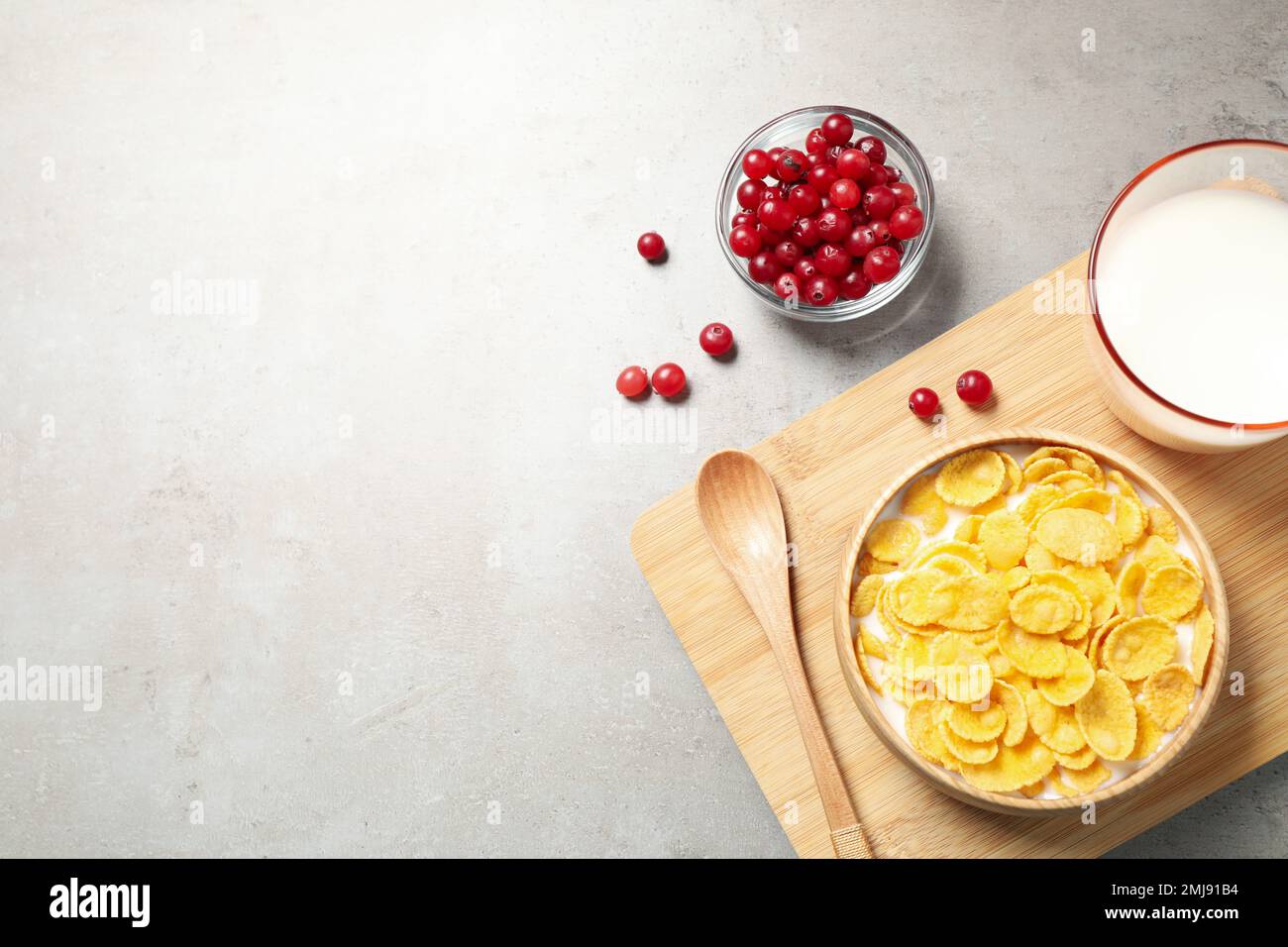 Flat lay composition with tasty corn flakes on light grey table. Space ...