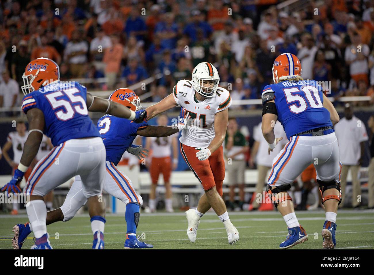Miami defensive lineman Scott Patchan (71) follows a play in front of ...