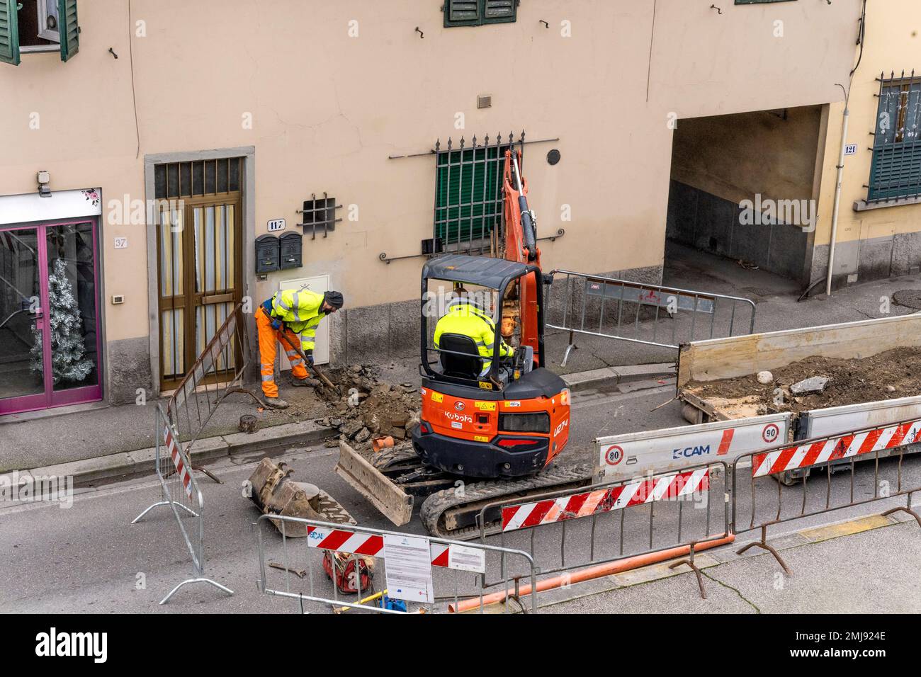 Maintenance hydraulic works in a street, Florence city center. Digging ...
