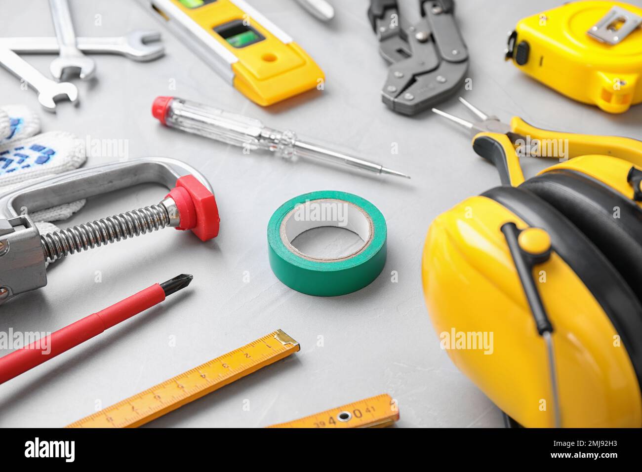 Different construction tools on light grey background Stock Photo - Alamy