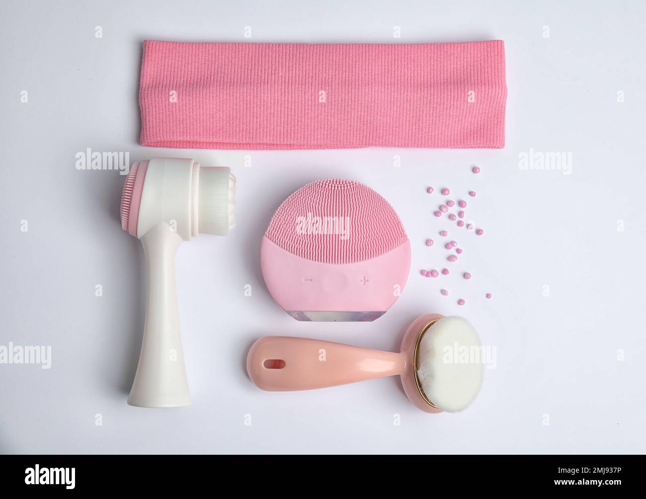 Composition with face cleansing brushes on white background, top view ...