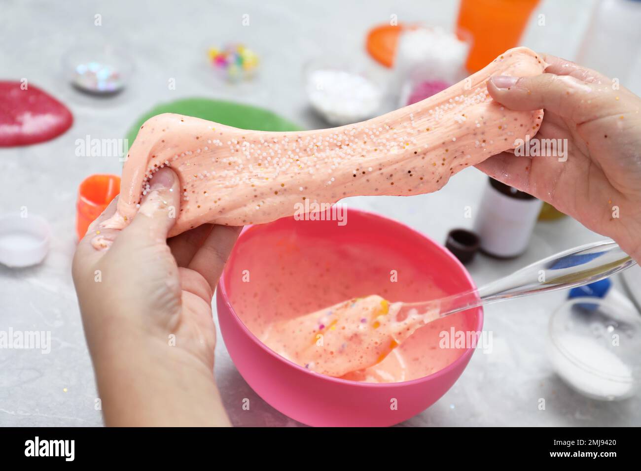 Little girl making DIY slime toy at table, closeup Stock Photo - Alamy