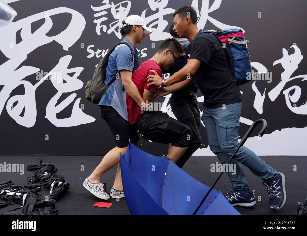 A mainland Chinese student, center, scuffles with protesting Hong Kong ...