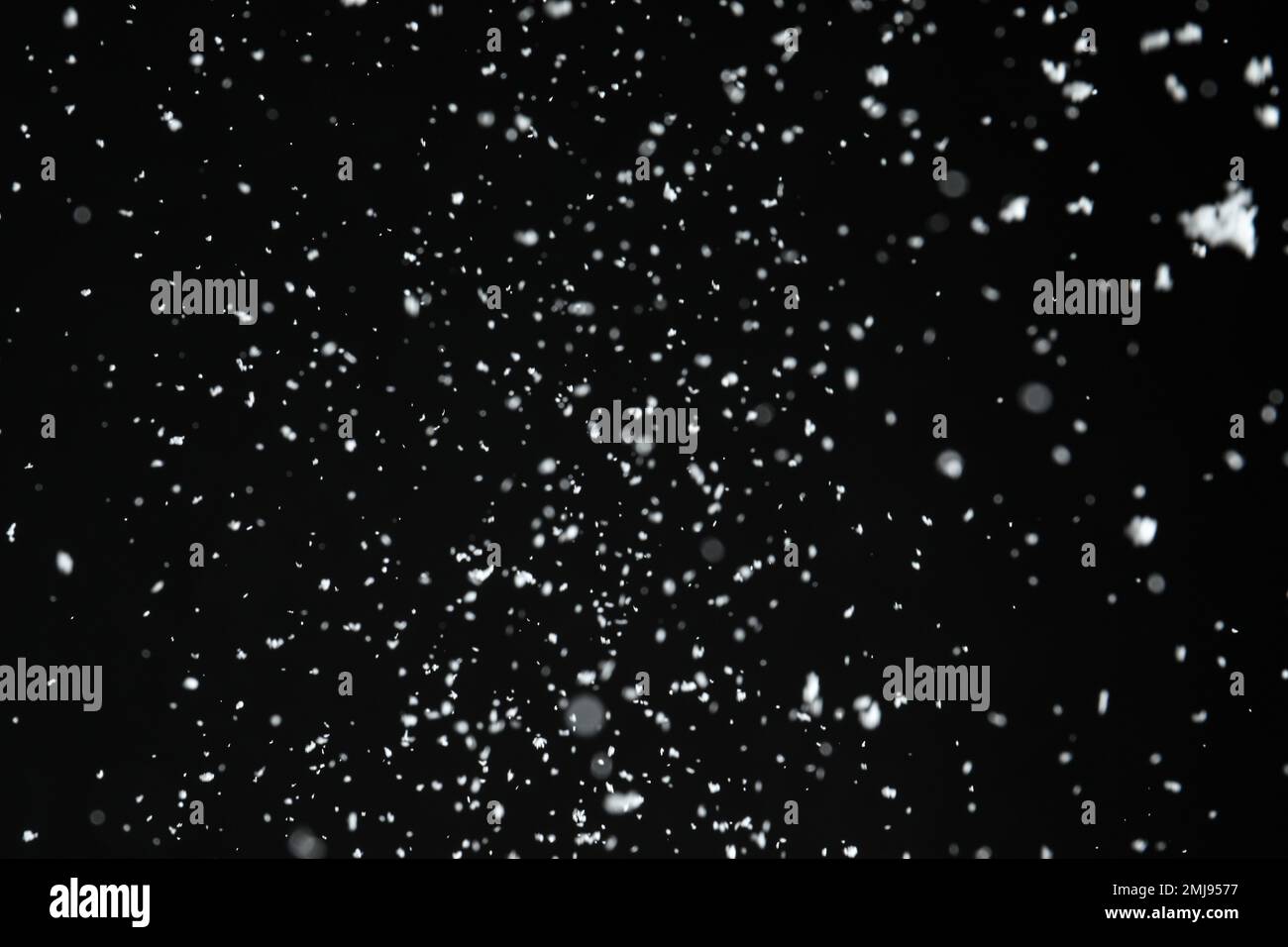 White snow falling down on black background Stock Photo - Alamy