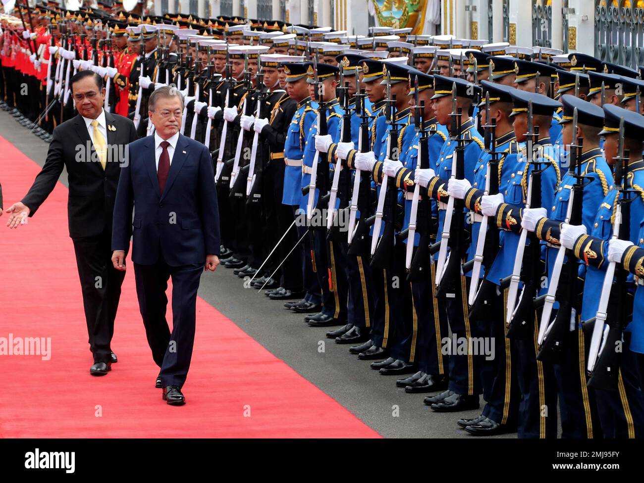 South Korean President Moon Jae-in, center, escorted by Thailand's ...