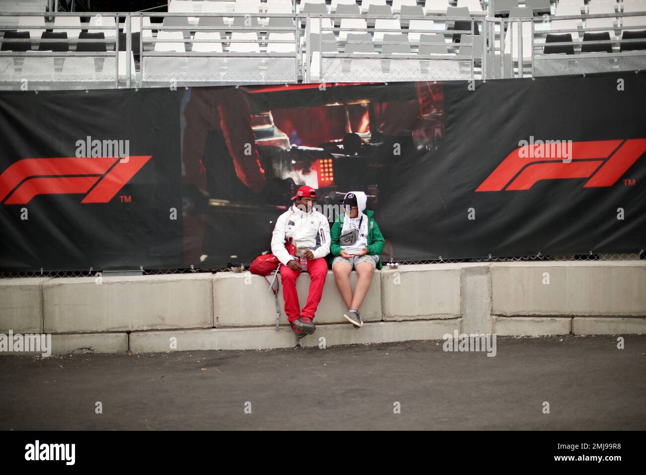 Two people sit in the fan zone at the Belgian Formula One Grand Prix ...