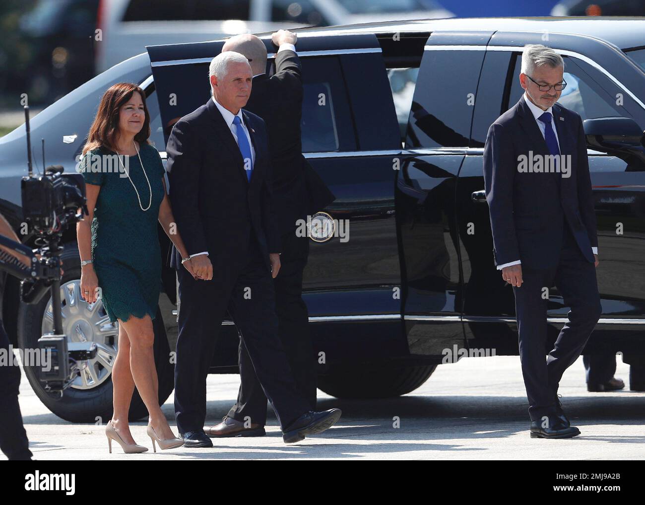 U.S. Vice President Mike Pence holds hands with his wife Karen as they ...