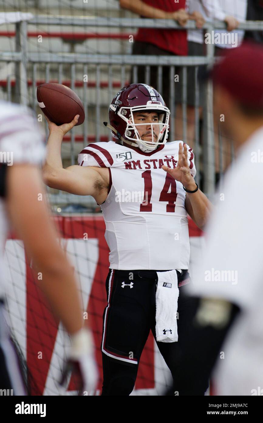 New Mexico State quarterback Josh Adkins (14) throws a pass during warm ...