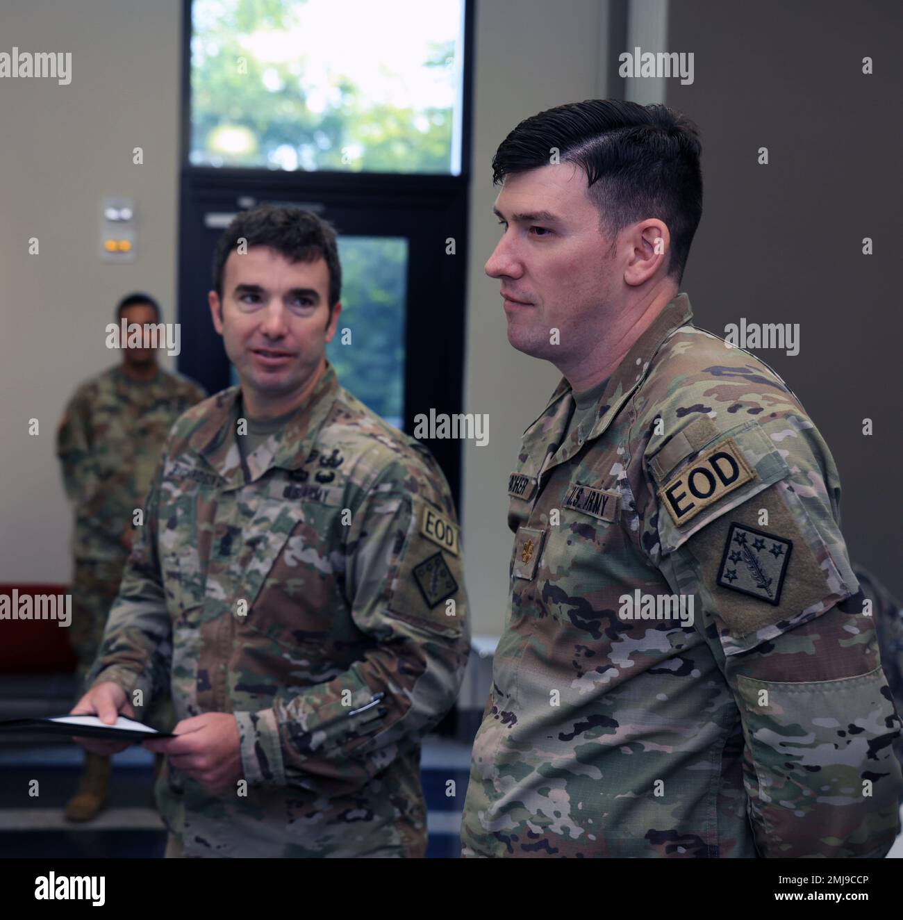Sgt. Maj. Joseph O. Richardson (left) prepares to pin Maj. Michael C ...
