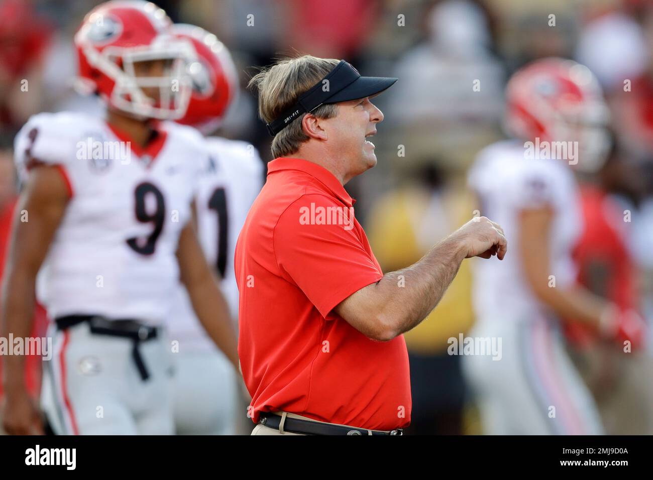 Georgia head coach Kirby Smart watches as players warm up before an ...
