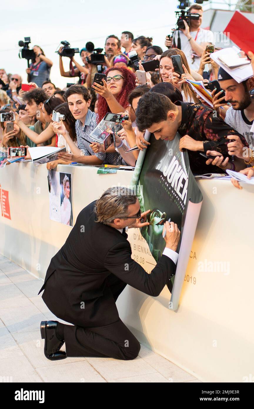 Actor Joaquin Phoenix signs autographs upon arrival at the premiere of ...
