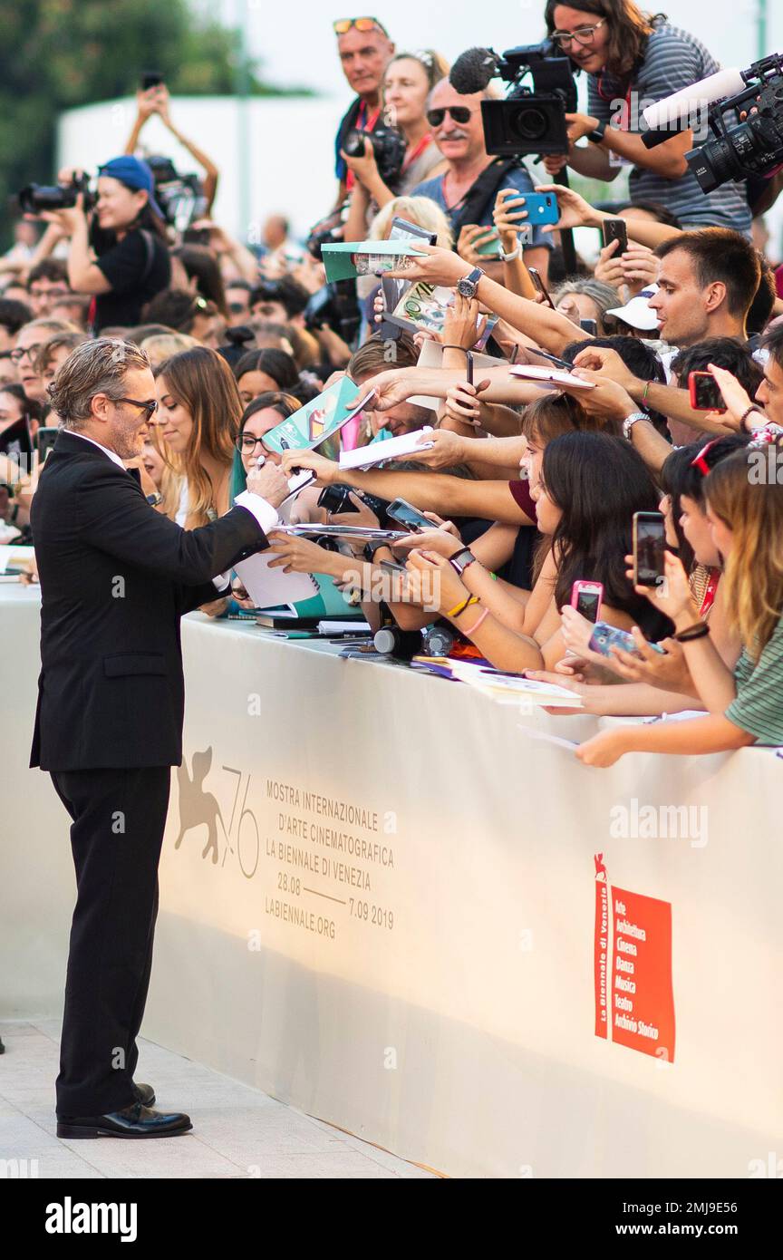 Actor Joaquin Phoenix signs autographs upon arrival at the premiere of ...