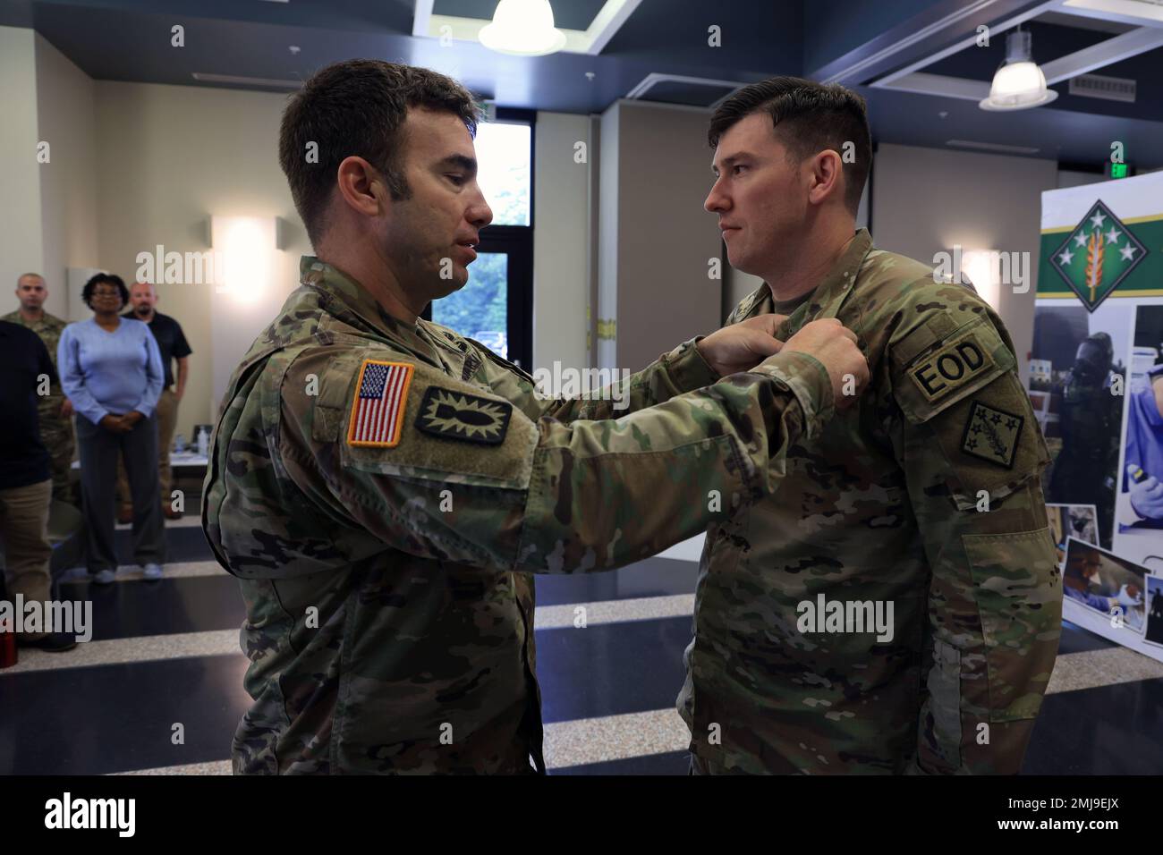 Sgt. Maj. Joseph O. Richardson (left) pins Maj. Michael C. Fancher with ...