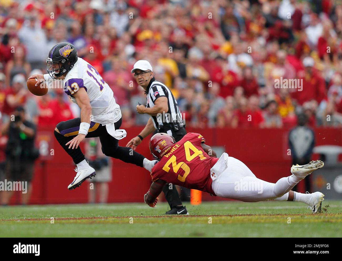 Northern Iowa quarterback Will McElvain, left, eludes a tackle by Iowa ...