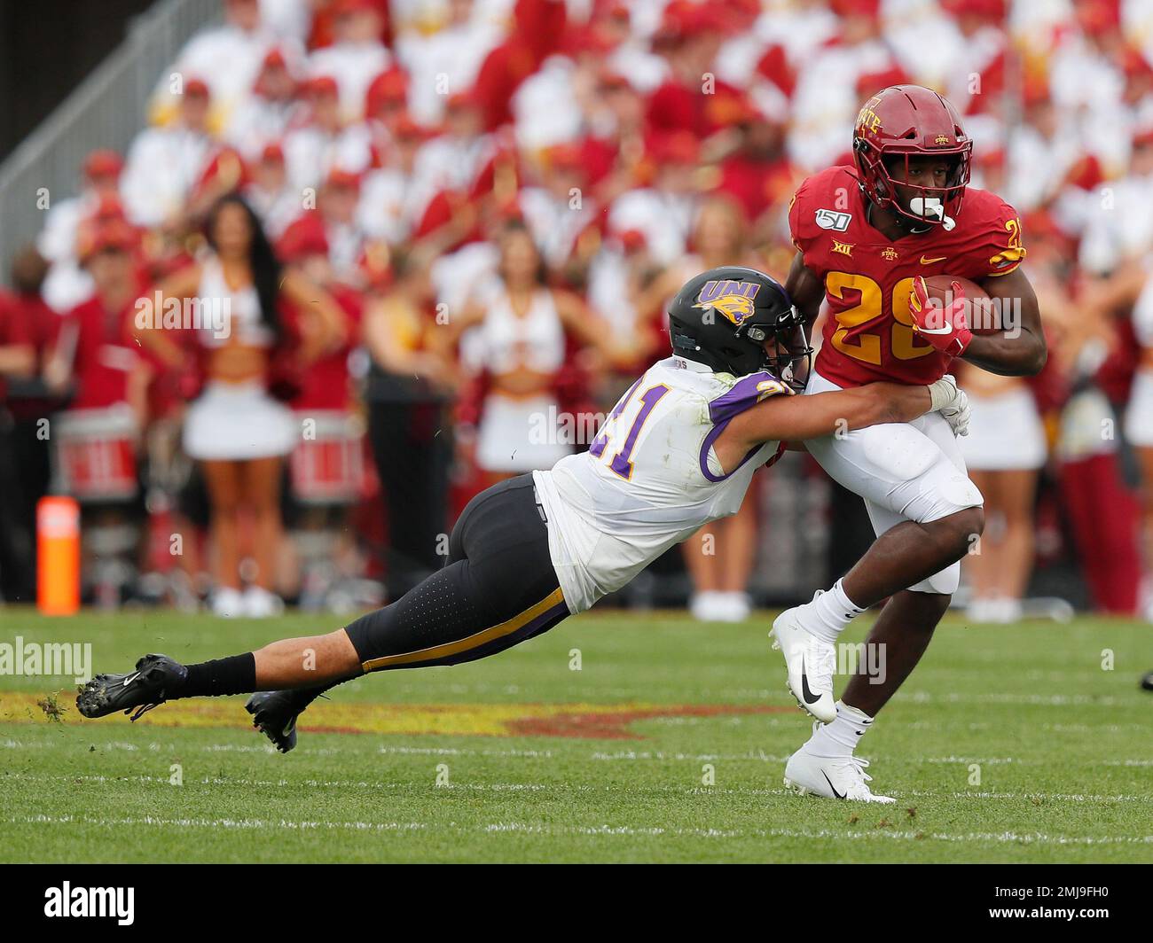 Iowa State running back Breece Hall, right, runs the ball as he is ...