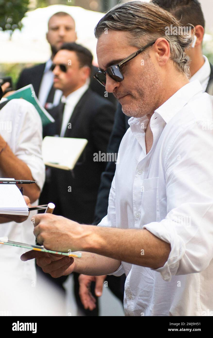 Actor Joaquin Phoenix signs autographs upon arrival for the photo call ...
