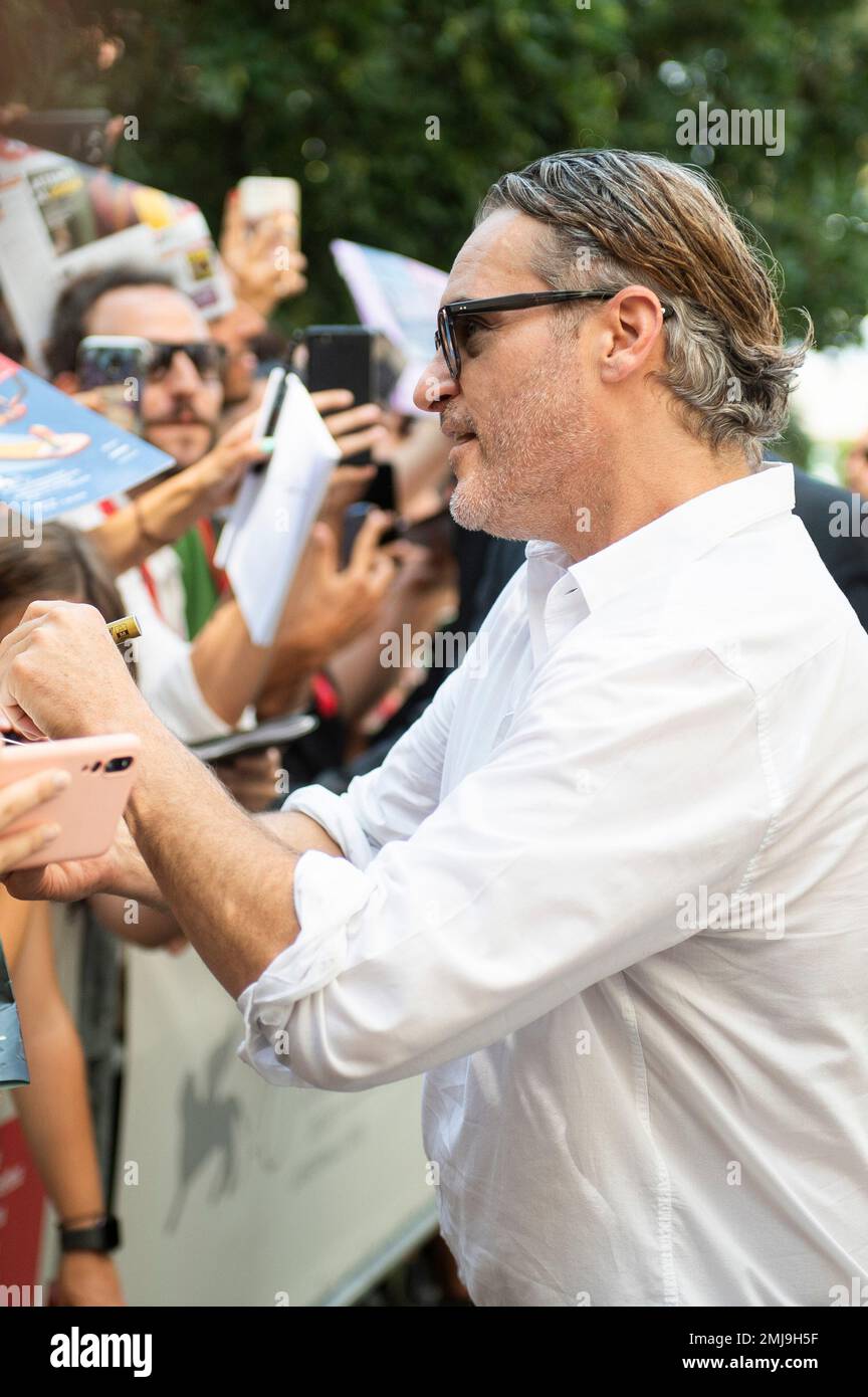 Actor Joaquin Phoenix signs autographs upon arrival for the photo call ...