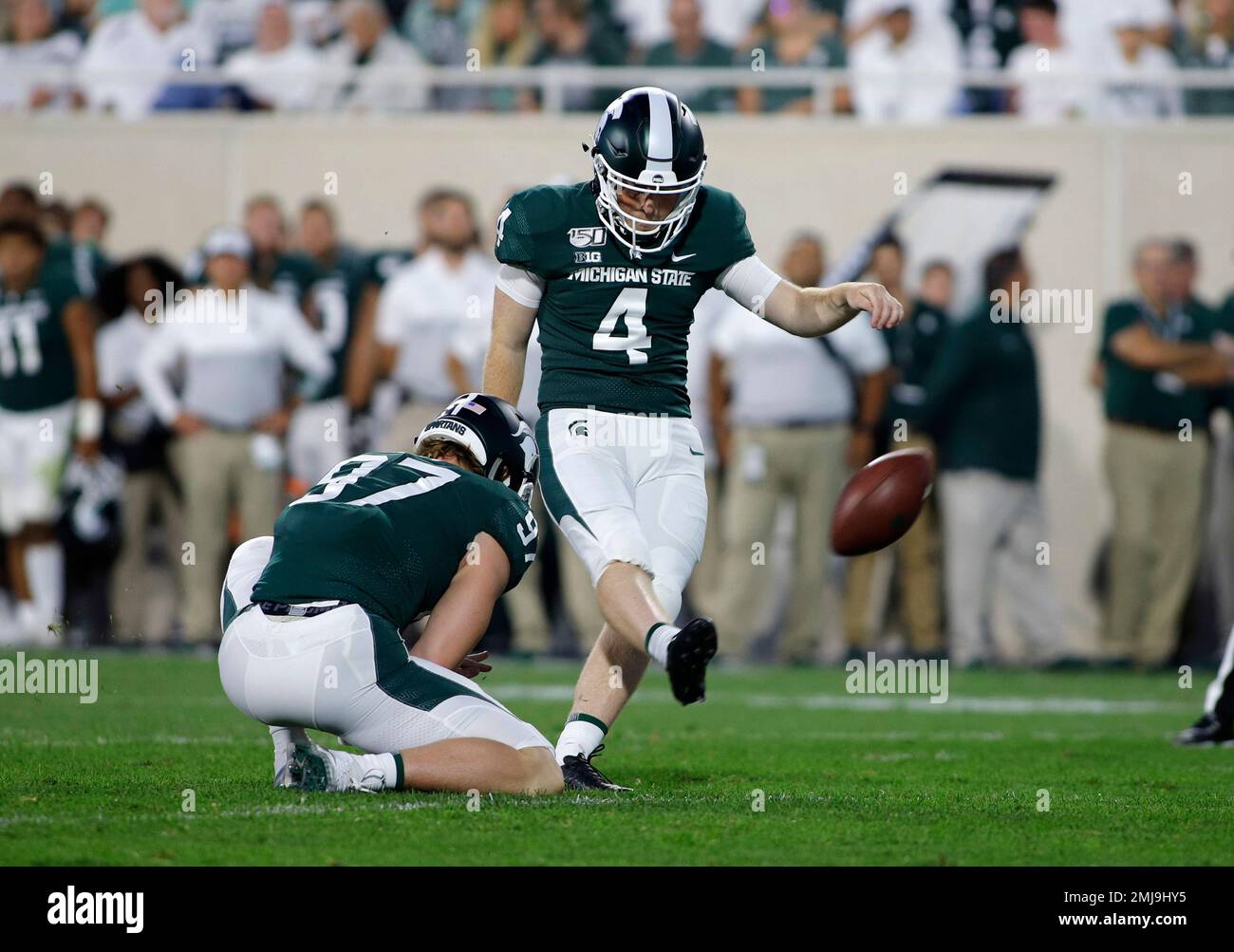 Michigan State's Matt Coghlin (4) kicks a field goal as Tyler Hunt ...