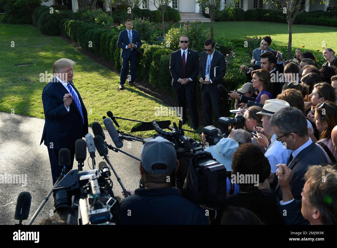 President Donald Trump talks to reporters on the South Lawn of the White House in Washington ...