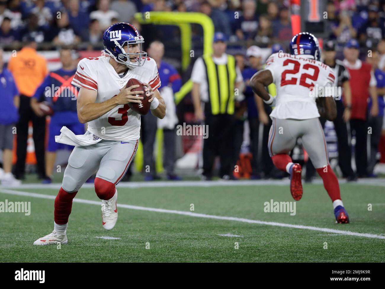 New York Giants quarterback Alex Tanney, left, rolls out to pass as New ...