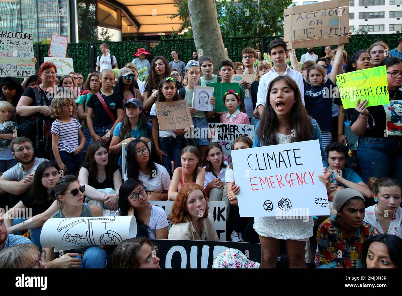 Swedish environmental activist Greta Thunberg, center in orange shirt ...