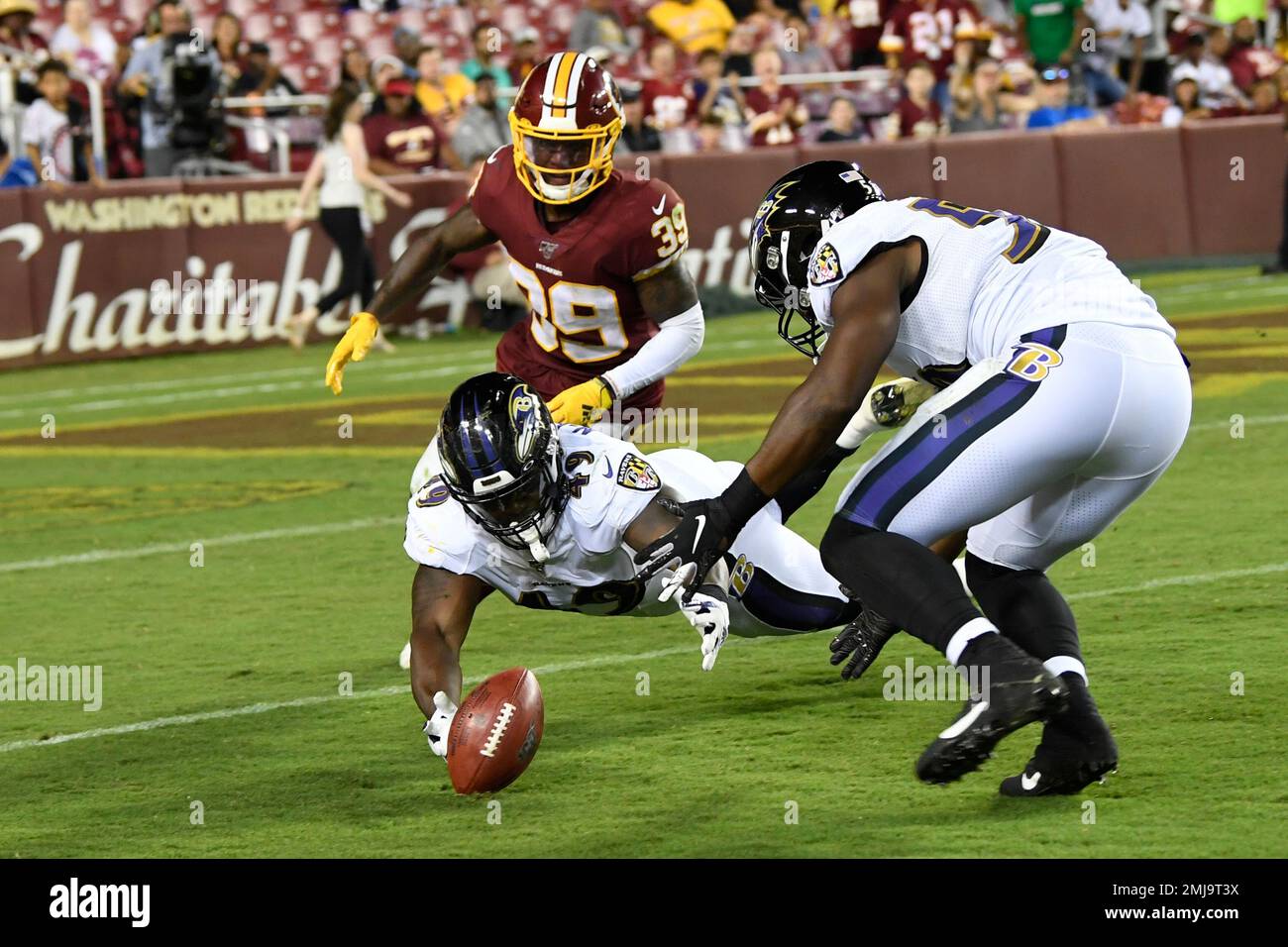 Baltimore Ravens fullback Christopher Ezeala (49) reaches out to ...