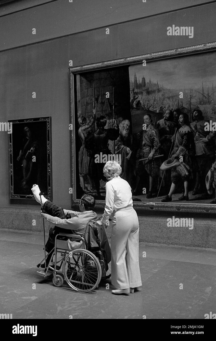 Plastered man in wheelchair visits El Prado Museum, Madrid, Spain ...