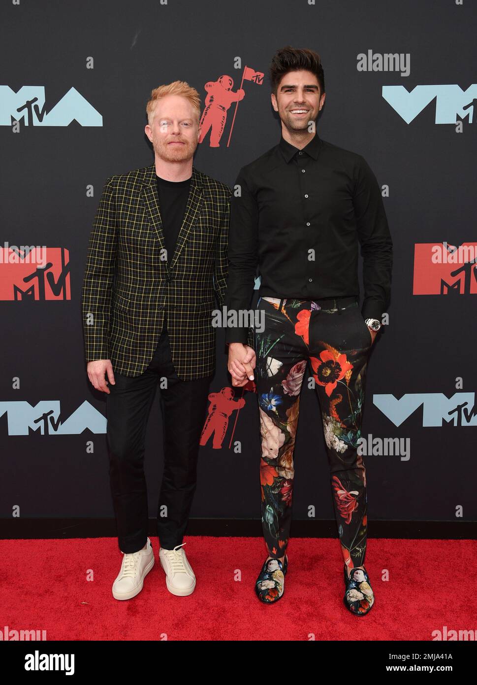 Jesse Tyler Ferguson, left, and husband Justin Mikita arrive at the MTV ...