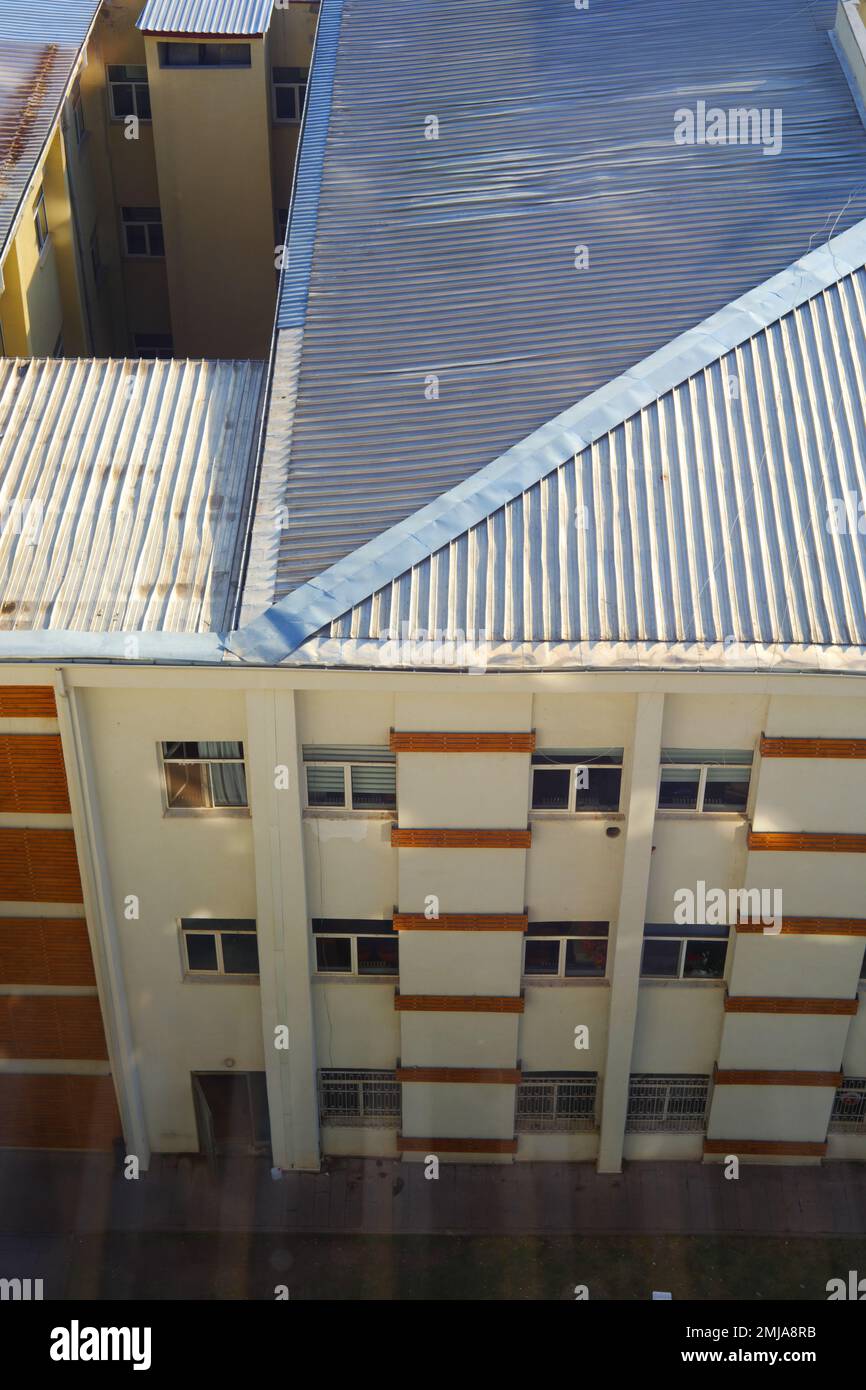 Metal rooftop of large buildings from the top at sunrise Stock Photo ...