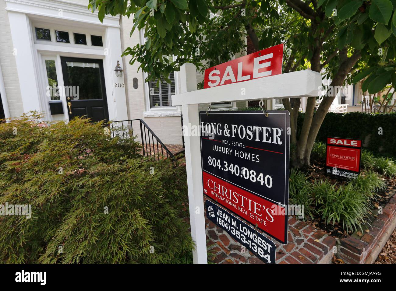 In this Aug. 16, 2019, photo a for sale signs beckon buyers to homes ...