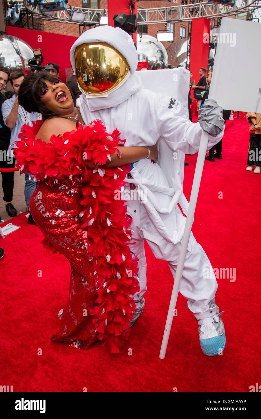 Lizzo, left, and MTV Moon Man arrive at the MTV Video Music Awards at ...