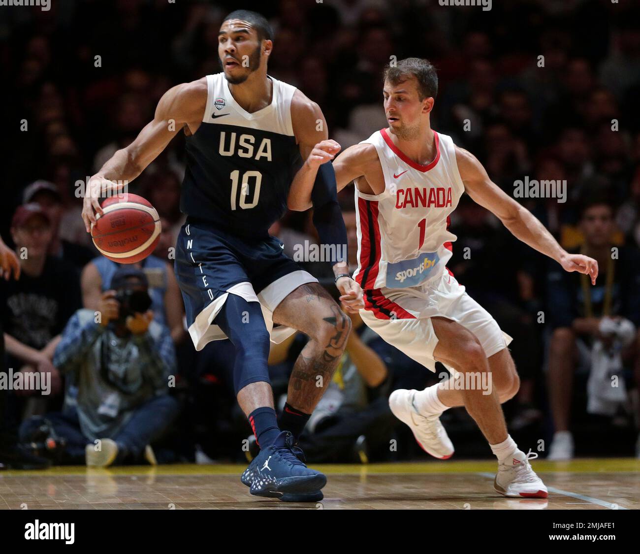 Canada's Kevin Pangos, right, hooks his arm through United States ...