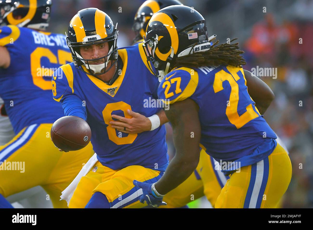 Los Angeles Rams quarterback Brandon Allen, left, hands off to running ...