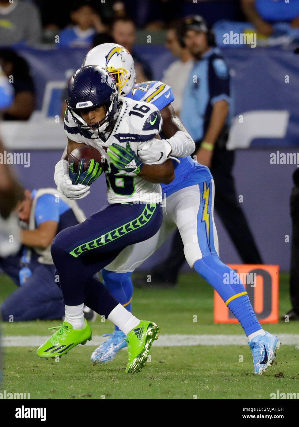 Seattle Seahawks wide receiver Tyler Lockett, left, is stopped by Los ...