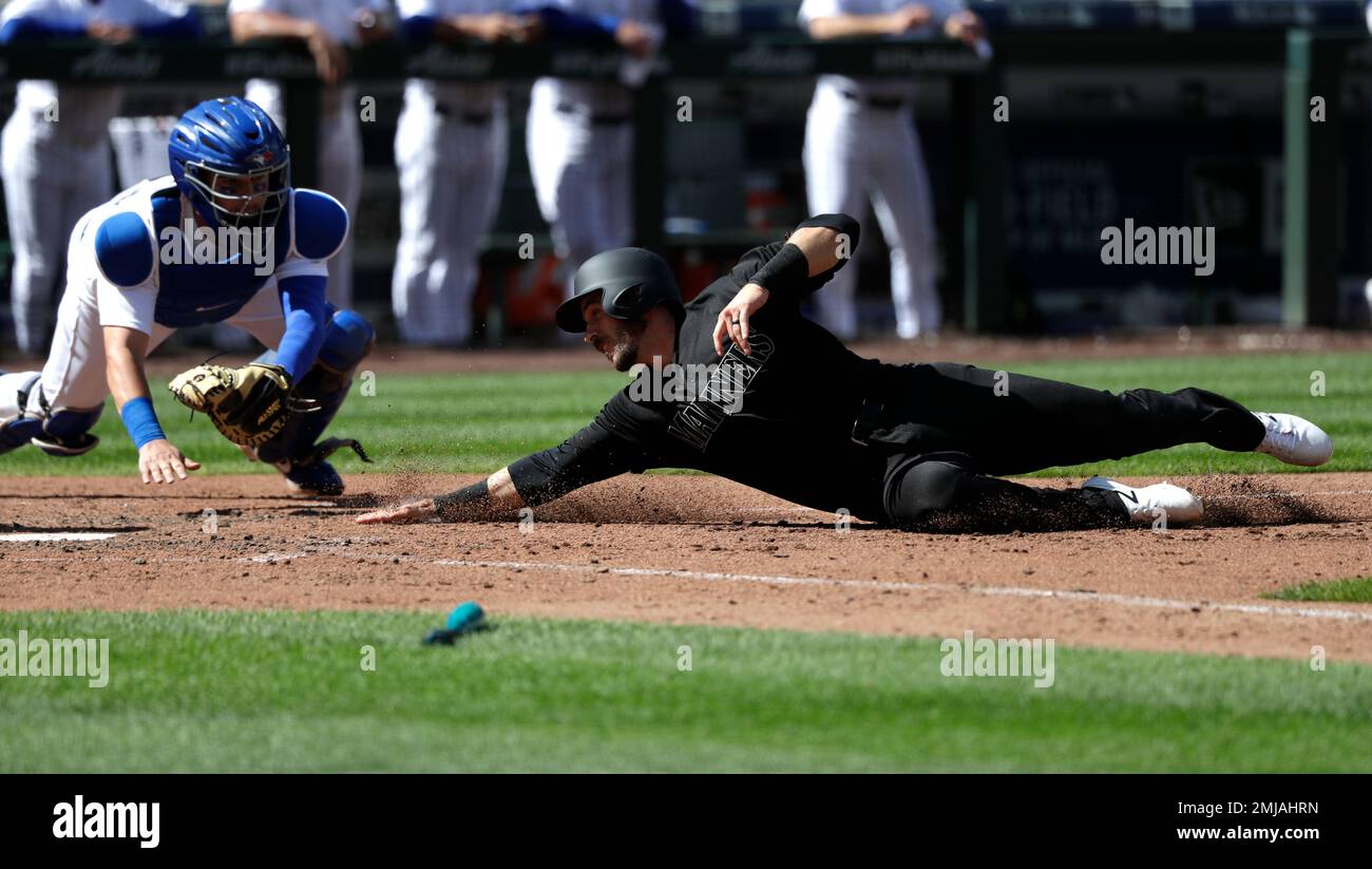 Seattle Mariners' Austin Nola, right, scores ahead of the tag by ...