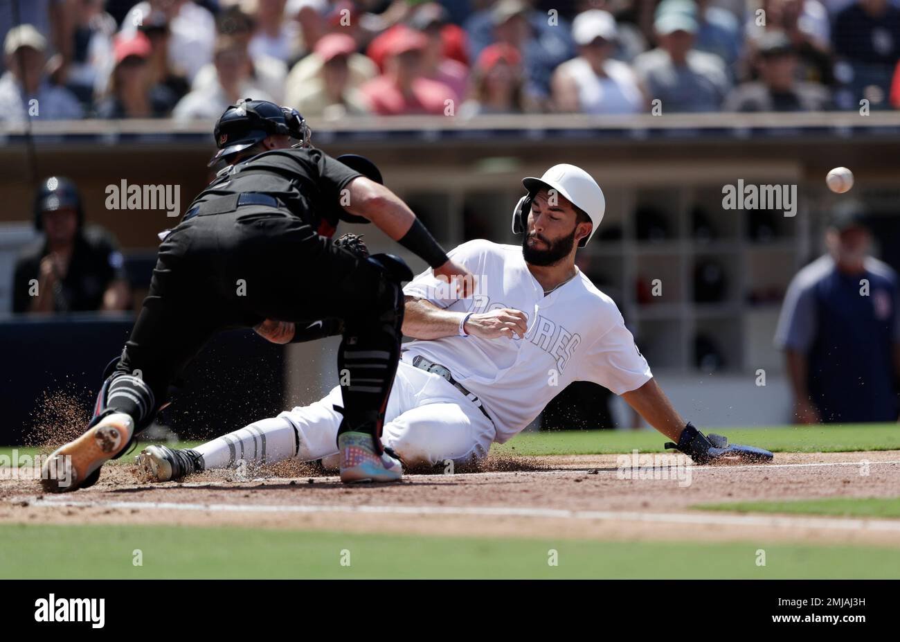 San Diego Padres' Eric Hosmer, right, slides in late to home before ...