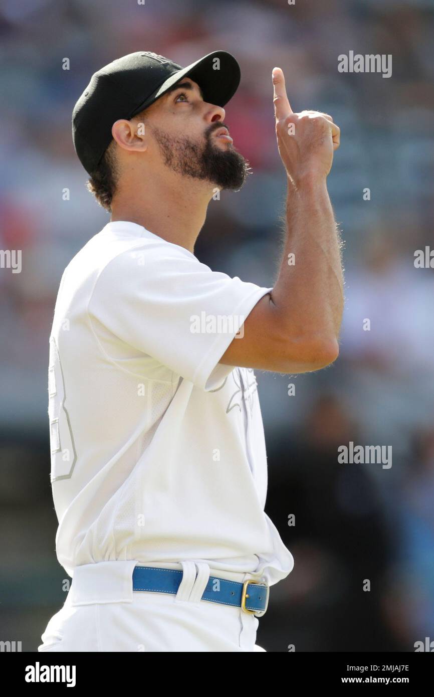 Kansas City Royals relief pitcher Jorge Lopez points up after the ...