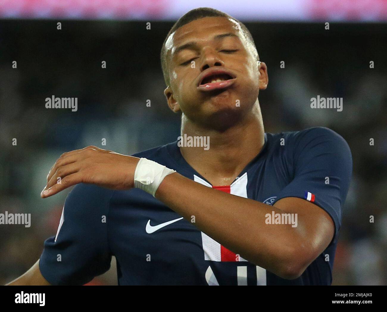 PSG's Kylian Mbappe grimaces during the French League One soccer match ...