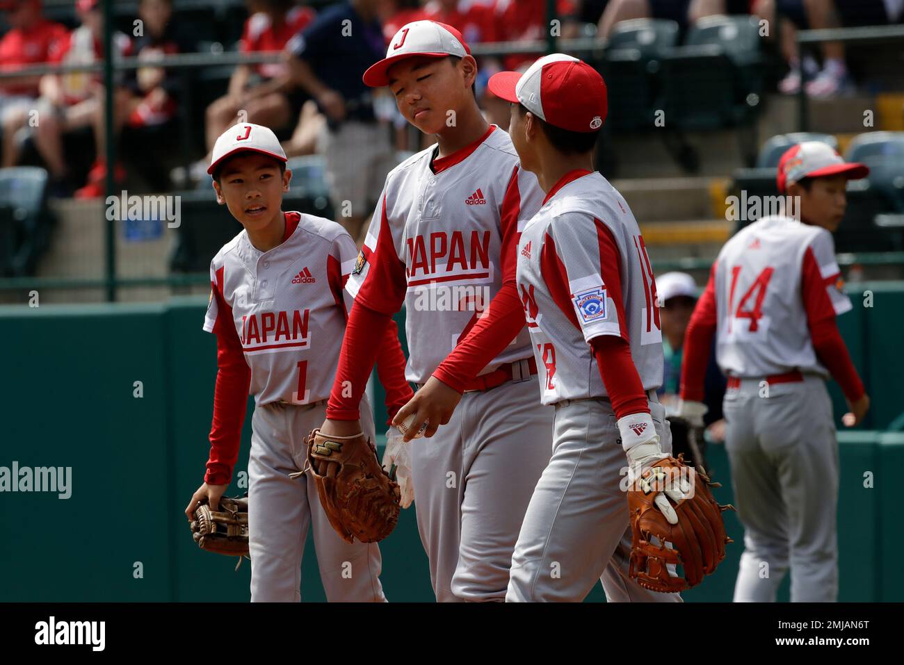 Japan pitcher Taishi Kawaguchi, center, is encouraged by Yuto Misaki ...
